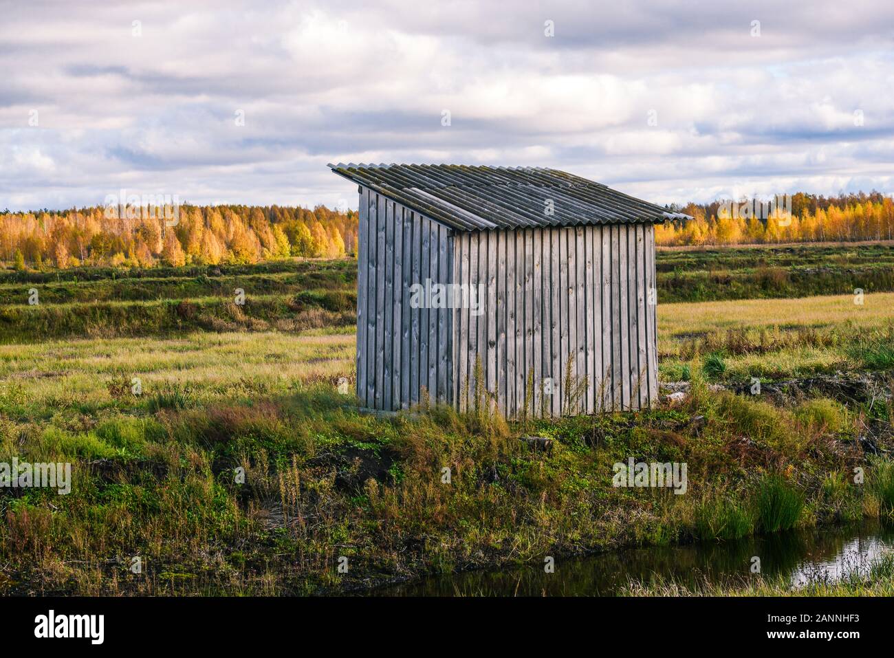 Wooden hut in the field. Holidays in the countryside. A small wooden ...