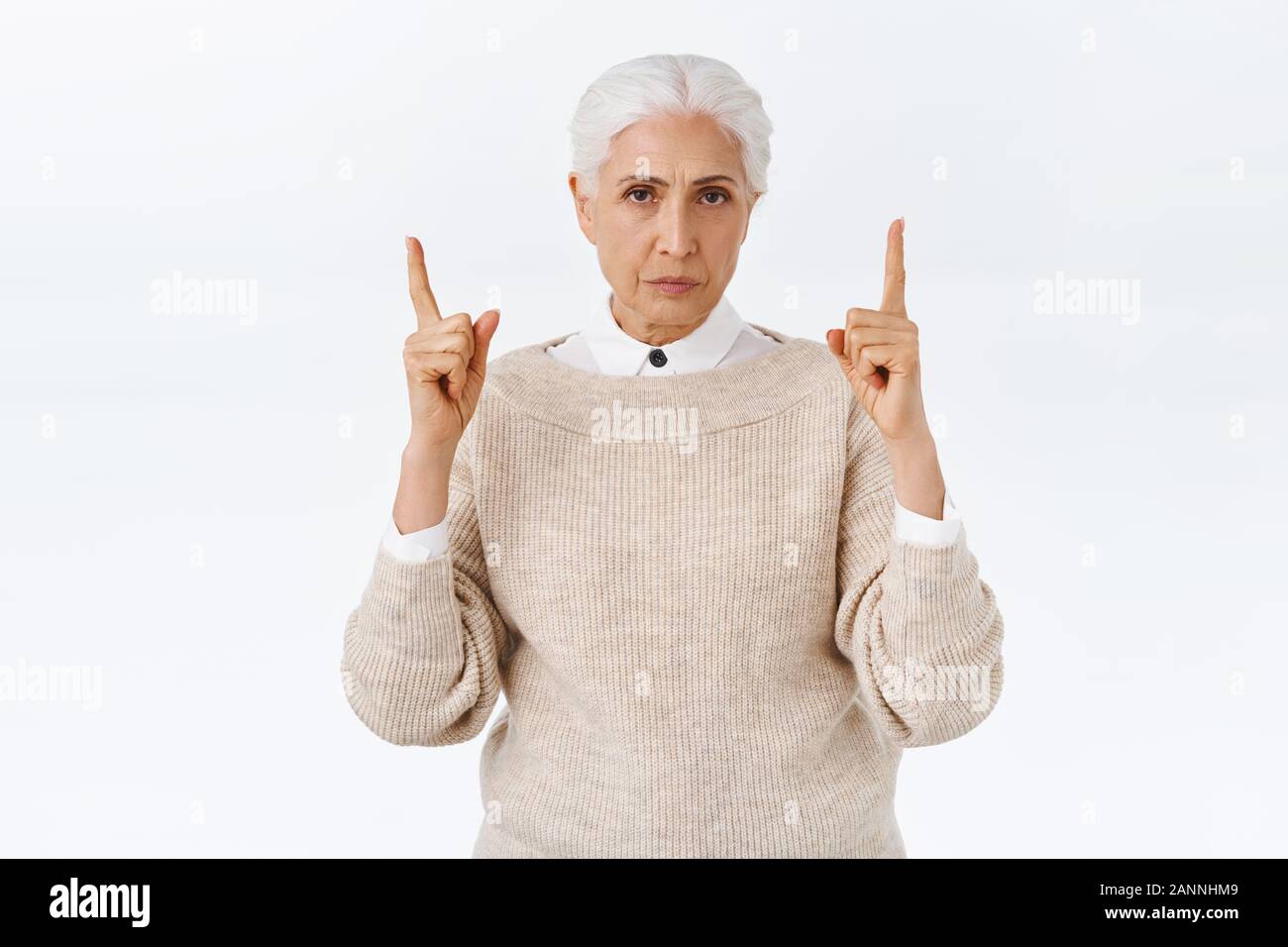 Disappointed, angry gloomy senior lady with grey combed hair, frowning ...