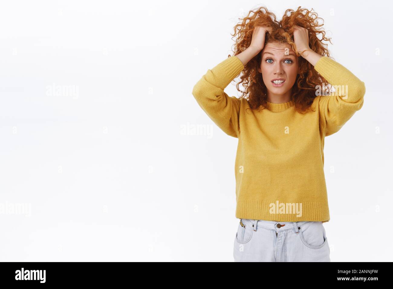 Troubled, confused pretty clumsy redhead girl with curly hair having ...