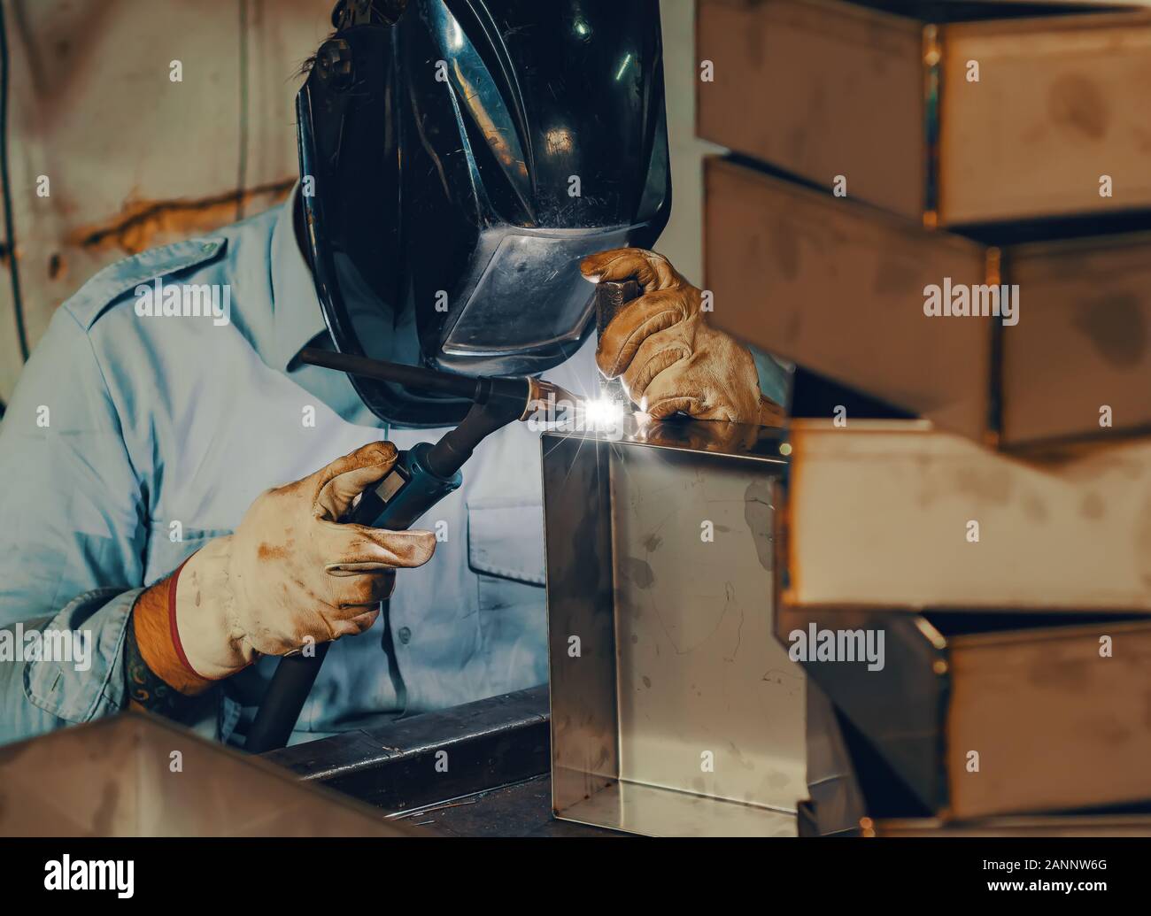 Welder welds a metal box Stock Photo - Alamy