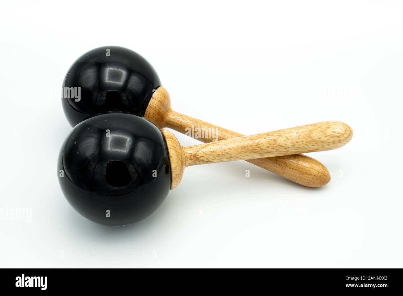Closeup of a pair of black maracas lying on a white underground Stock ...