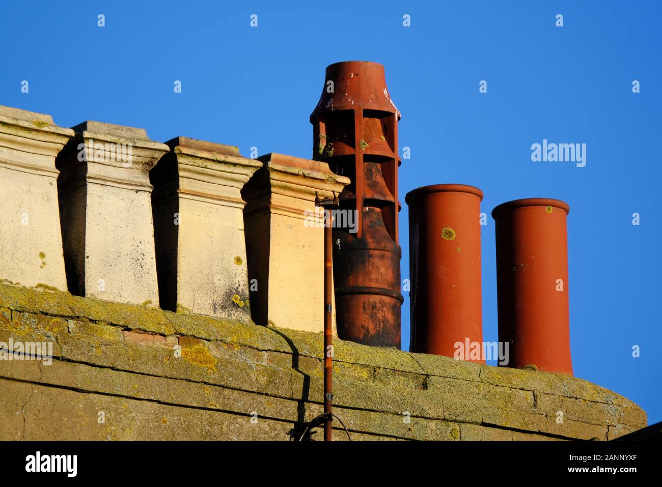 Types of chimney on rooftop in old town centre Stock Photo - Alamy