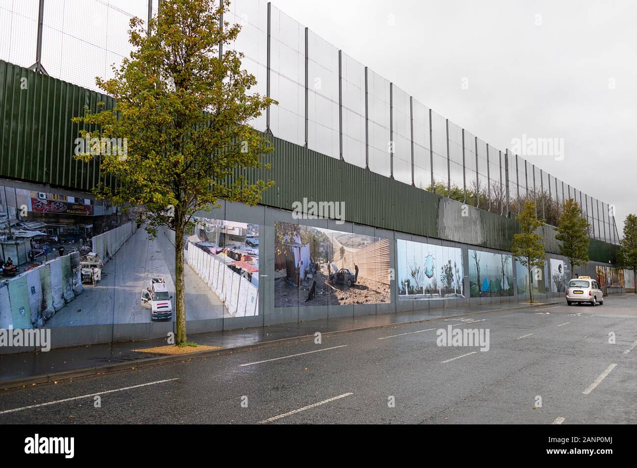 Car parked by by large photos of walls dividing countries around the ...