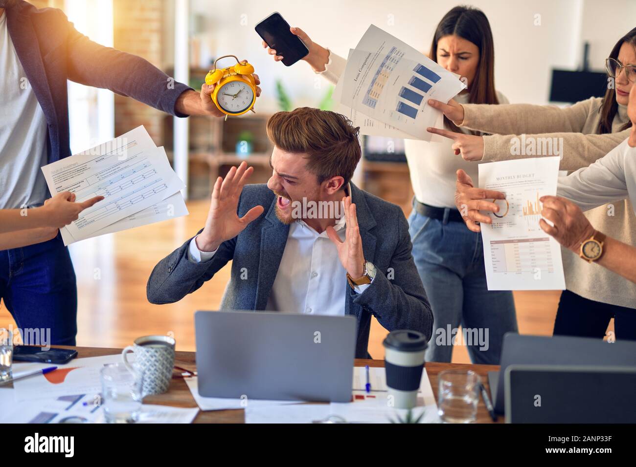 Group of business workers working together. Partners stressing one of ...