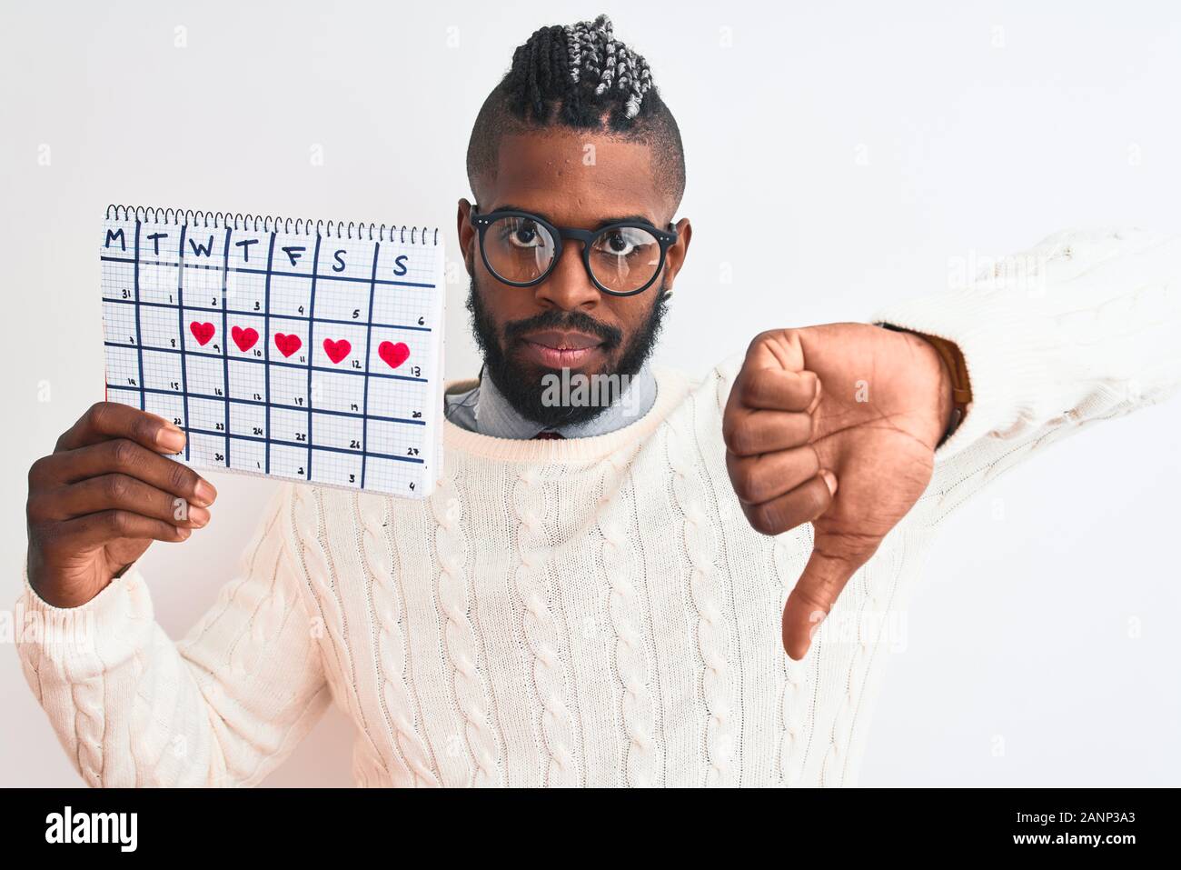 African american man with braids holding period calendar over isolated ...