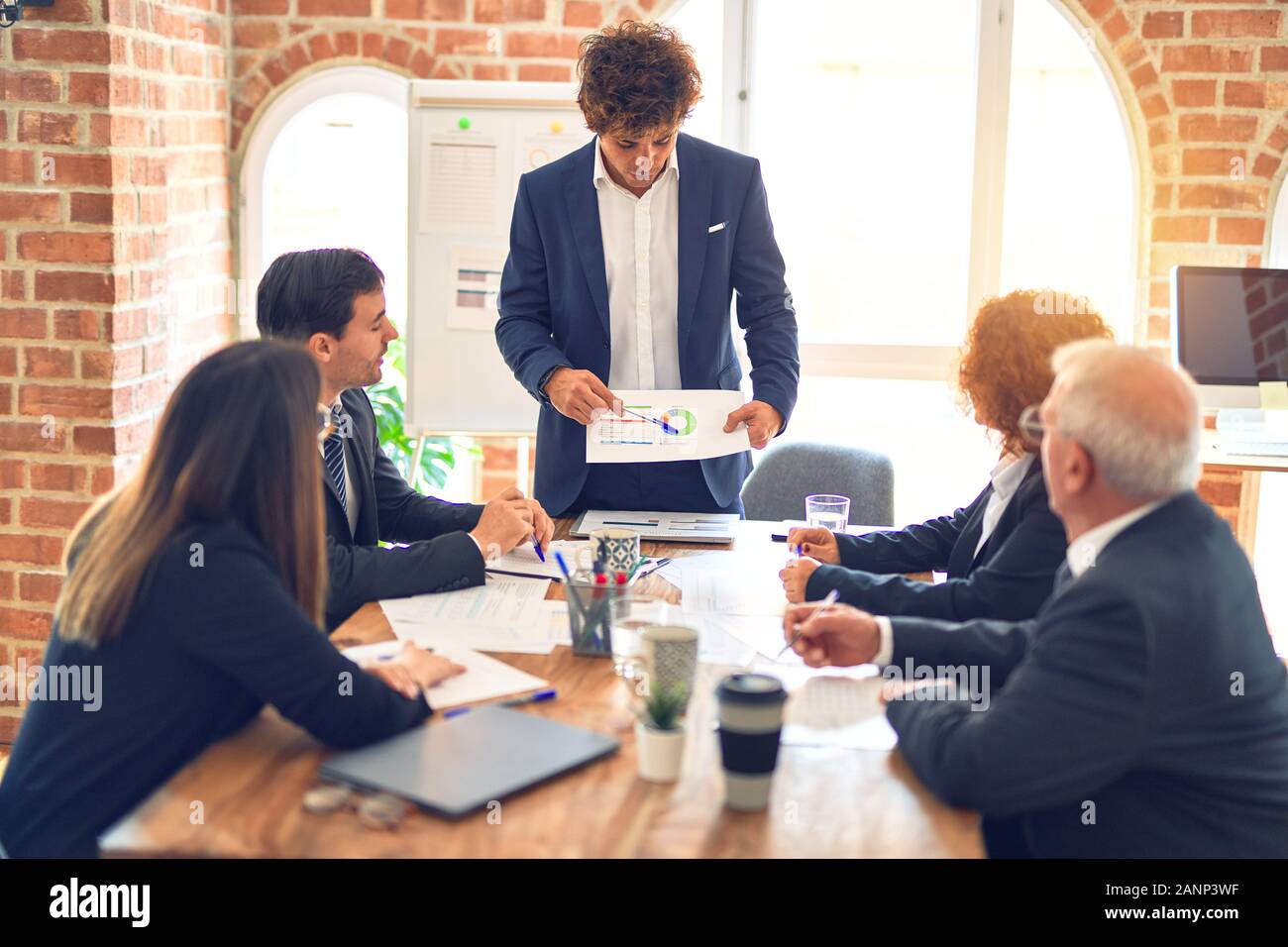 Group of business workers working together in a meeting. Listening one ...