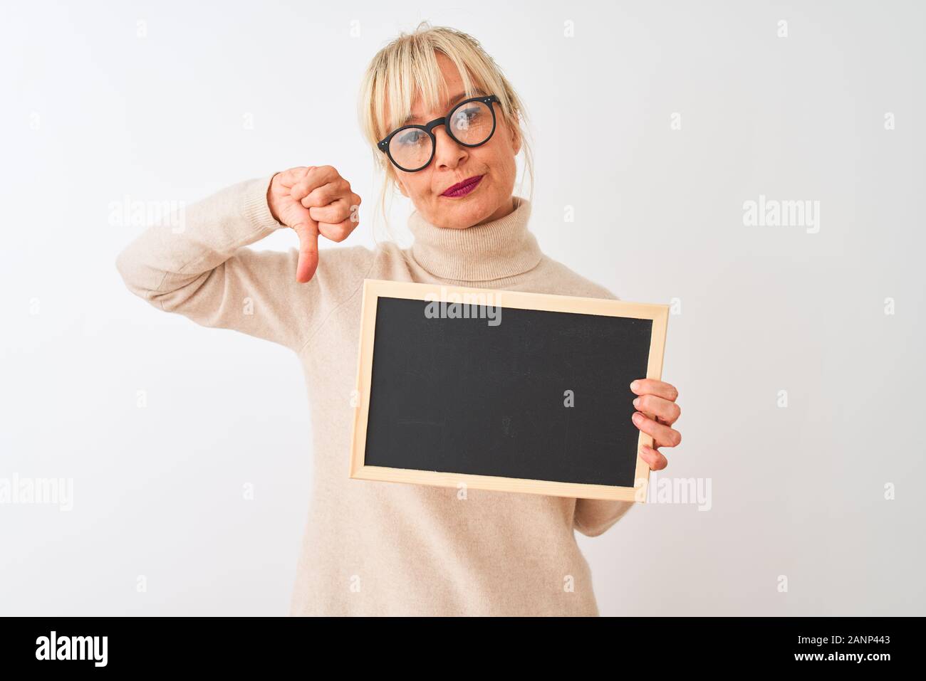 Middle age woman wearing glasses holding blackboard over isolated white ...