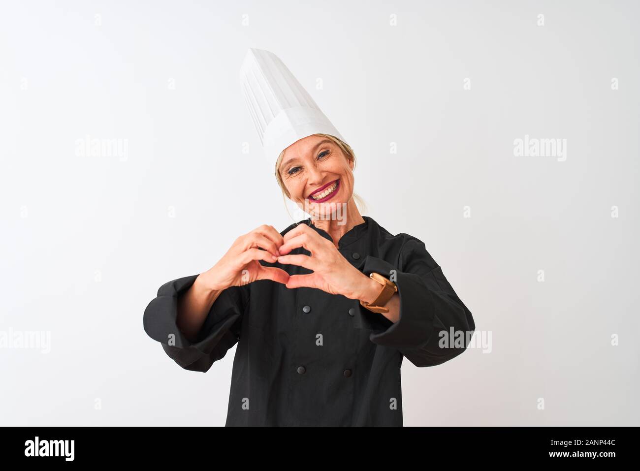 Middle age chef woman wearing uniform and hat standing over isolated ...