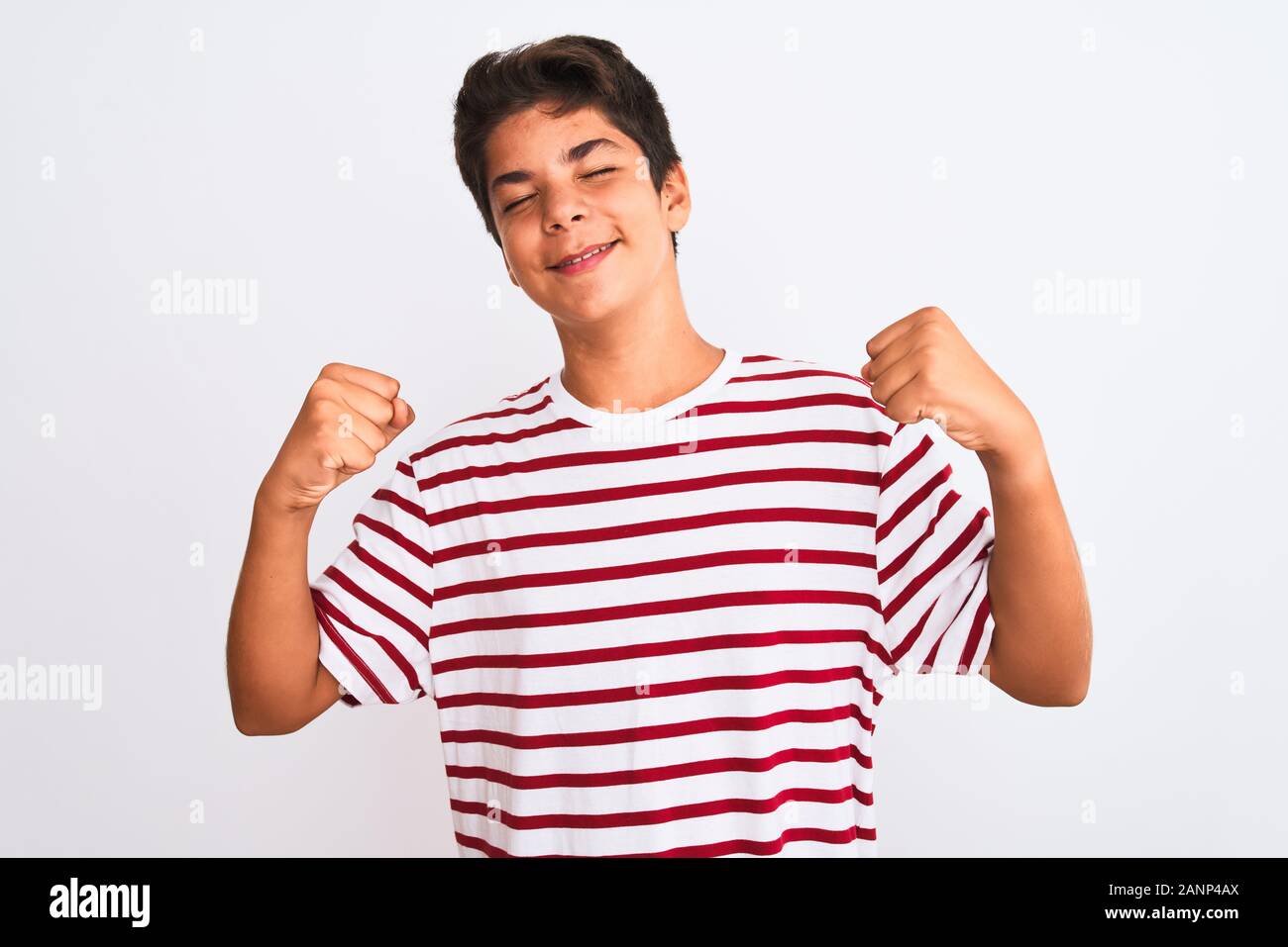 Handsome teenager boy standing over white isolated background very ...