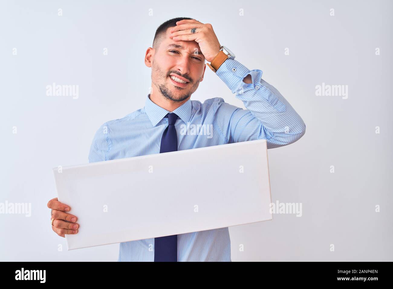 Young business man holding blank banner over isolated background ...
