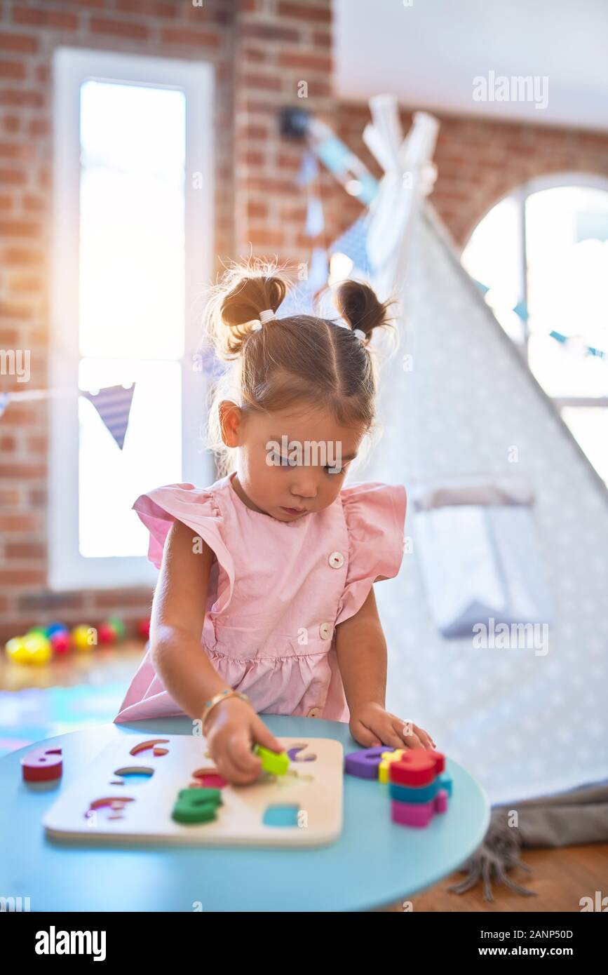 Young beautiful toddler learning mathematics playing with maths game at ...