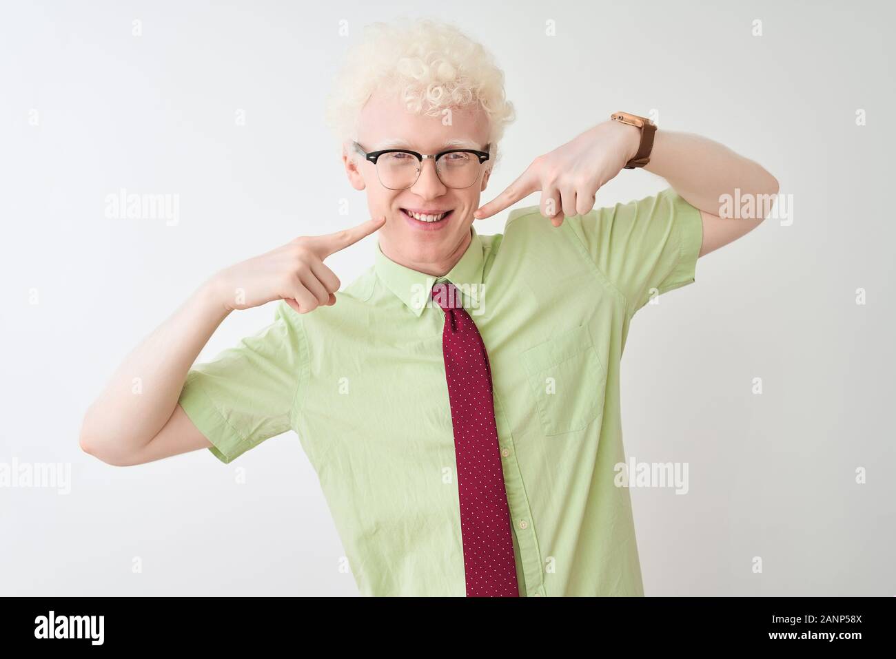 Young albino businessman wearing shirt and tie standing over isolated ...