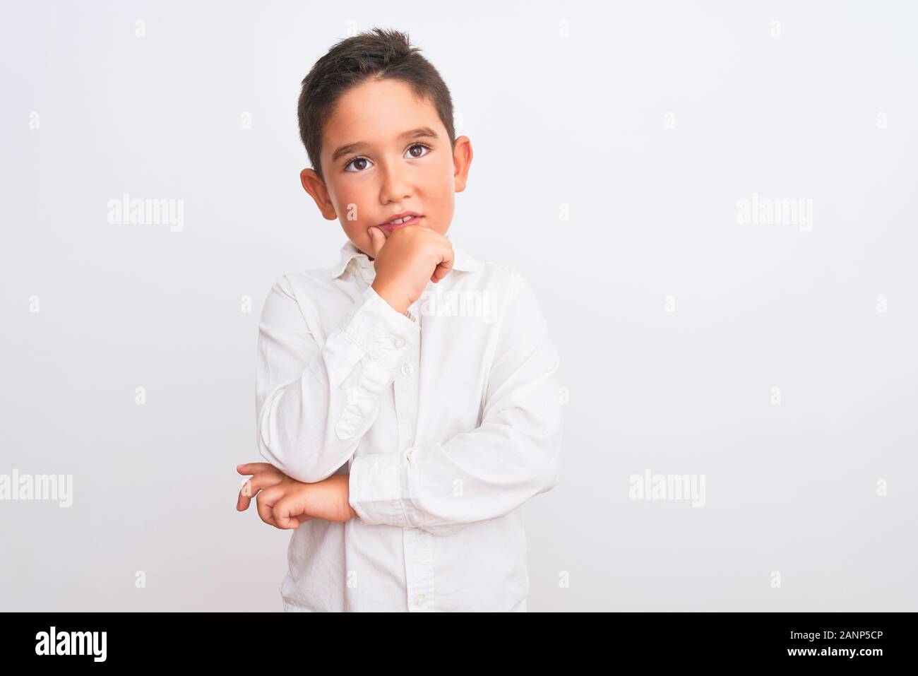Beautiful kid boy wearing elegant shirt standing over isolated white ...
