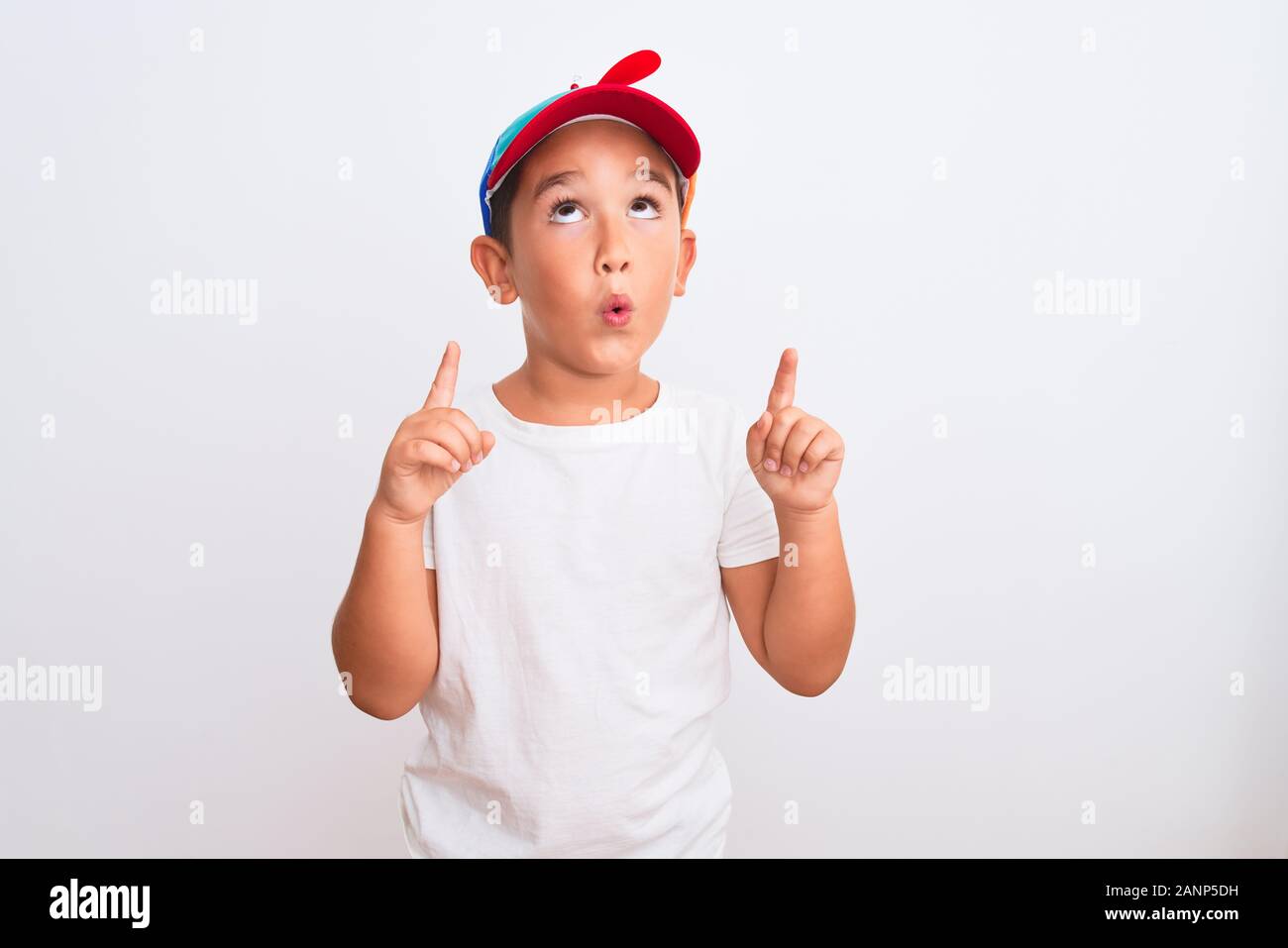Beautiful kid boy wearing fanny colorful cap with propeller over ...