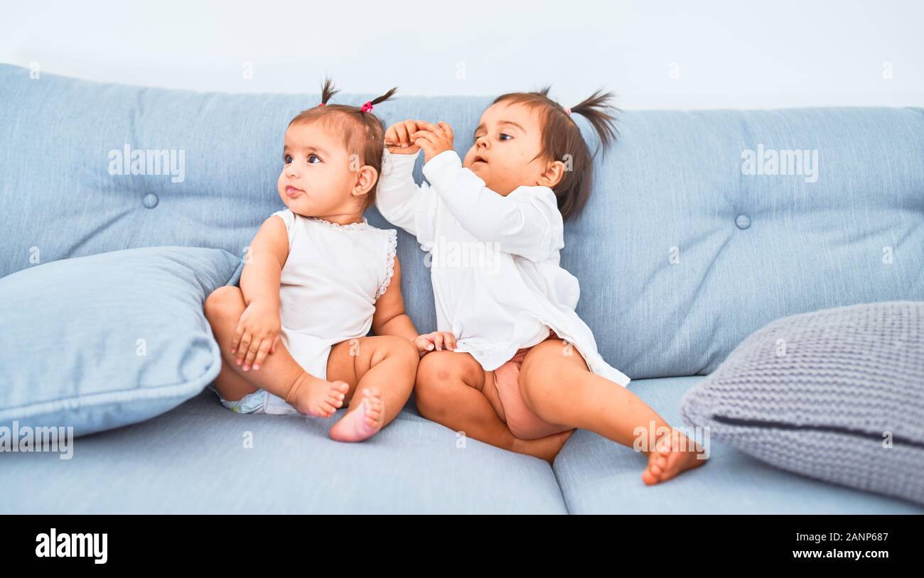 Beautiful infant happy girls playing together at home kindergarten ...