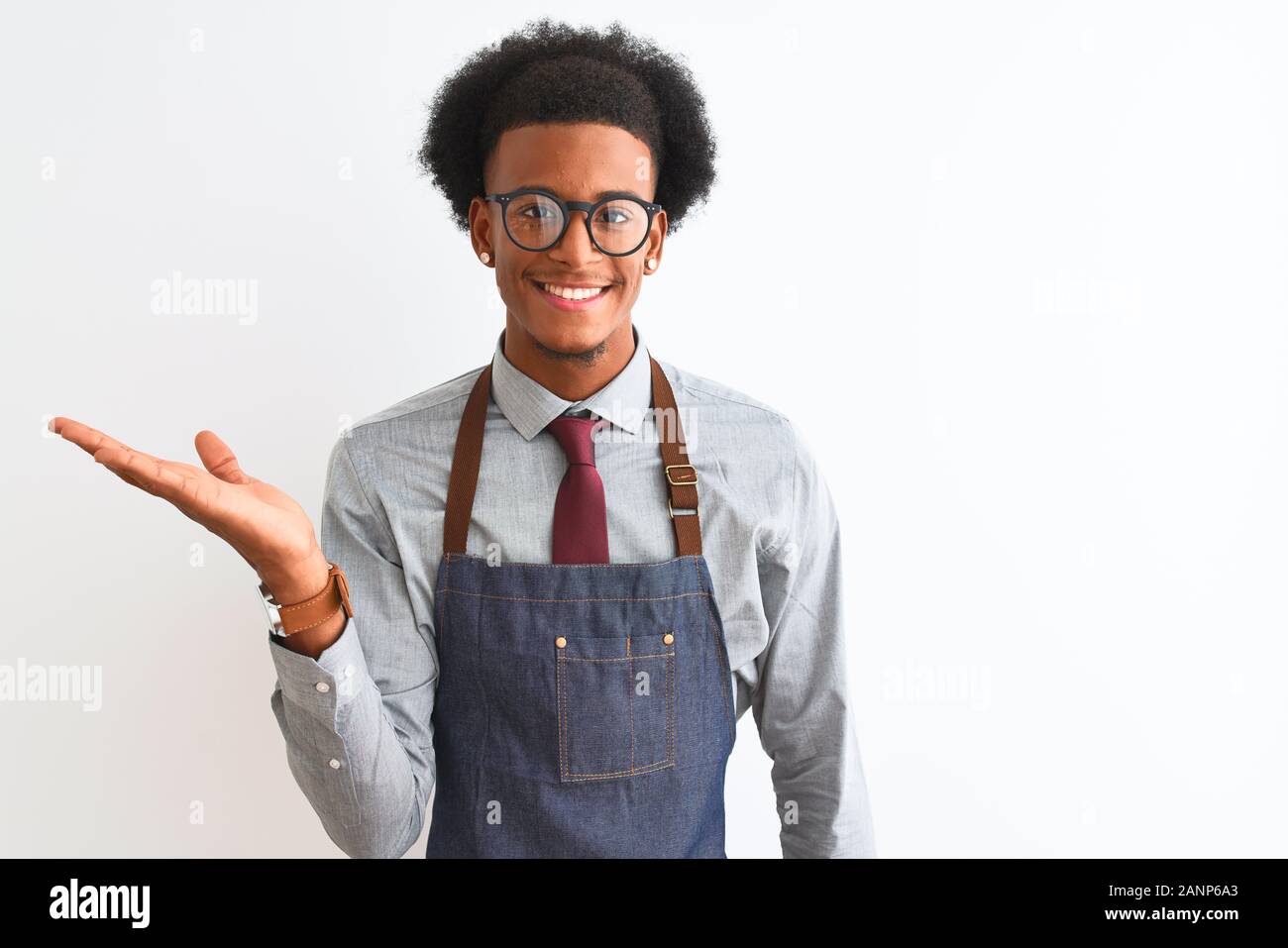 Young african american shopkeeper man wearing apron glasses over ...