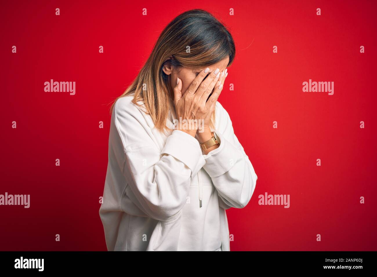 Middle age beautiful sportswoman wearing casual sweatshirt over ...