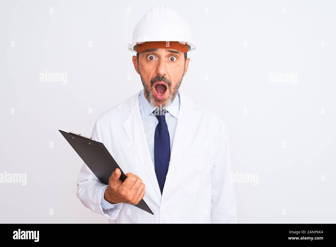 Senior engineer man wearing security helmet holding clipboard over ...