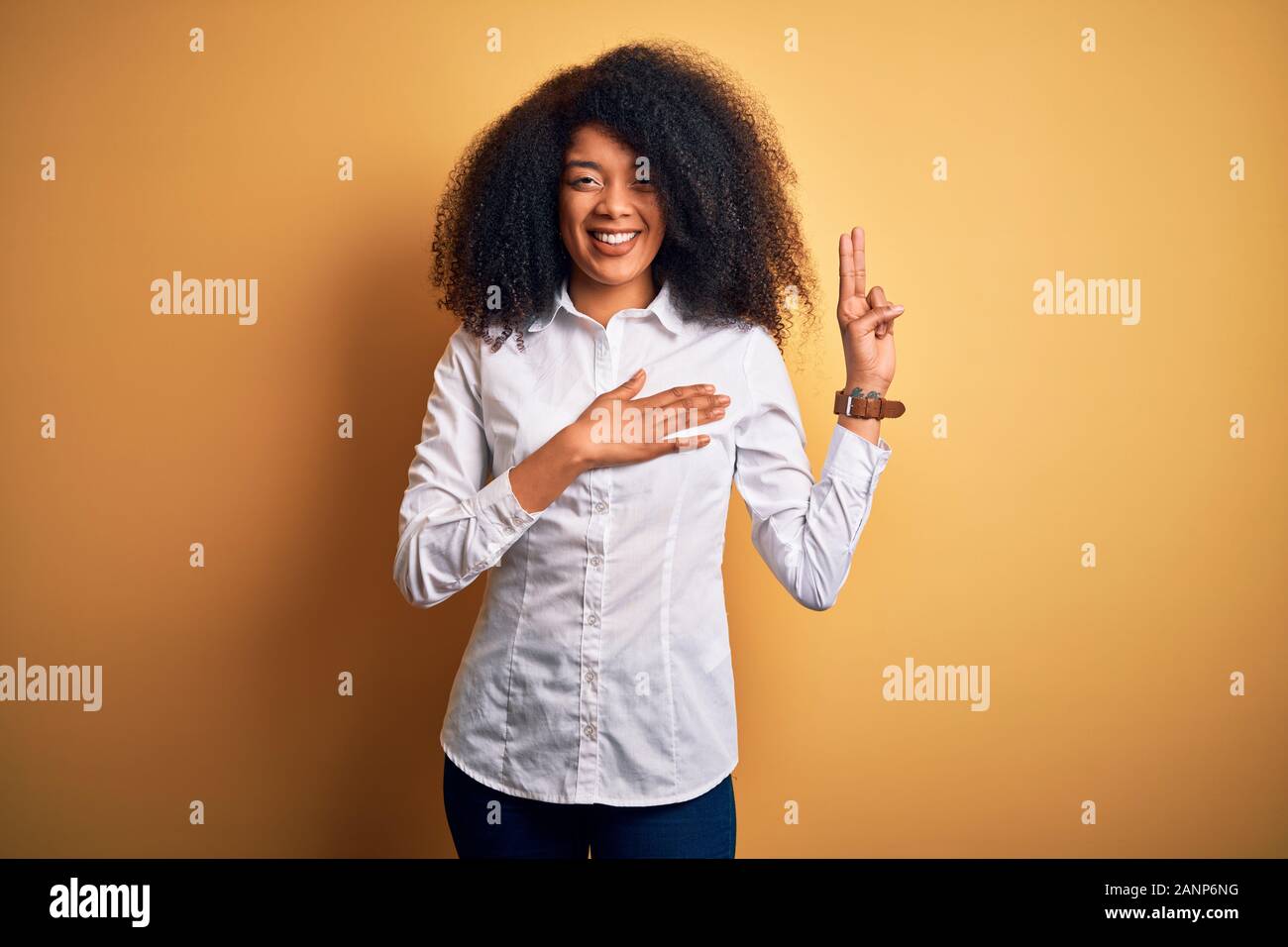 Young beautiful african american elegant woman with afro hair standing ...