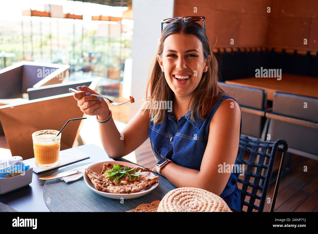 Young beautiful woman sitting at restaurant enjoying summer vacation ...