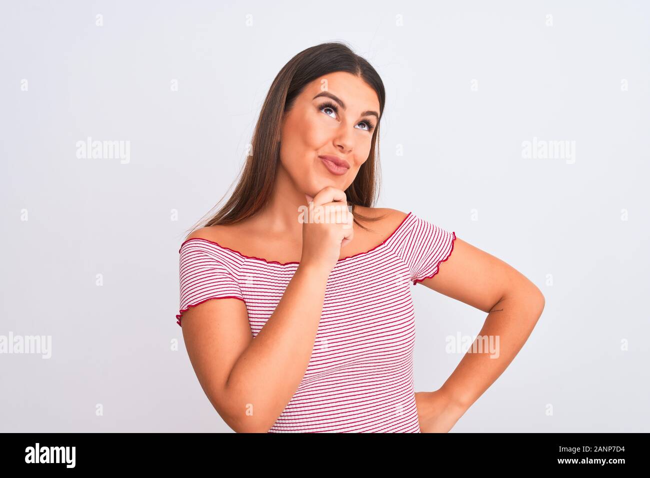 Portrait of beautiful young woman standing over isolated white ...