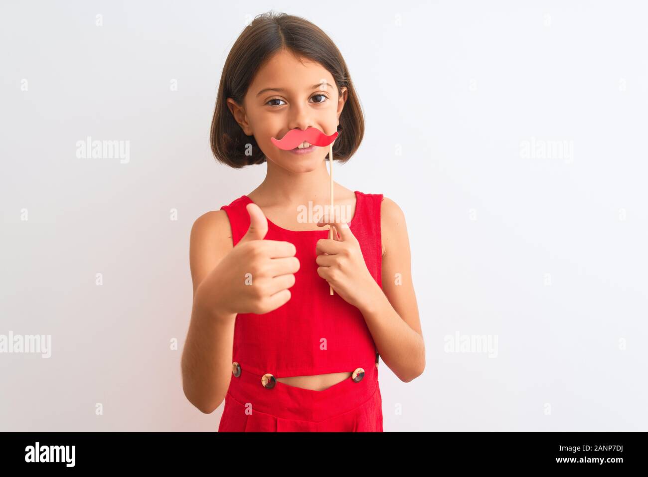 Beautiful child girl holding fanny party mustache standing over ...