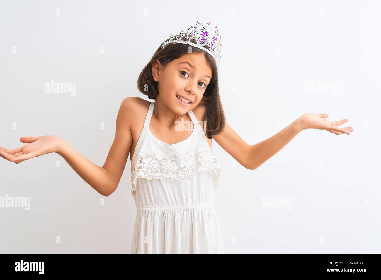 Beautiful child girl wearing princess crown standing over isolated ...