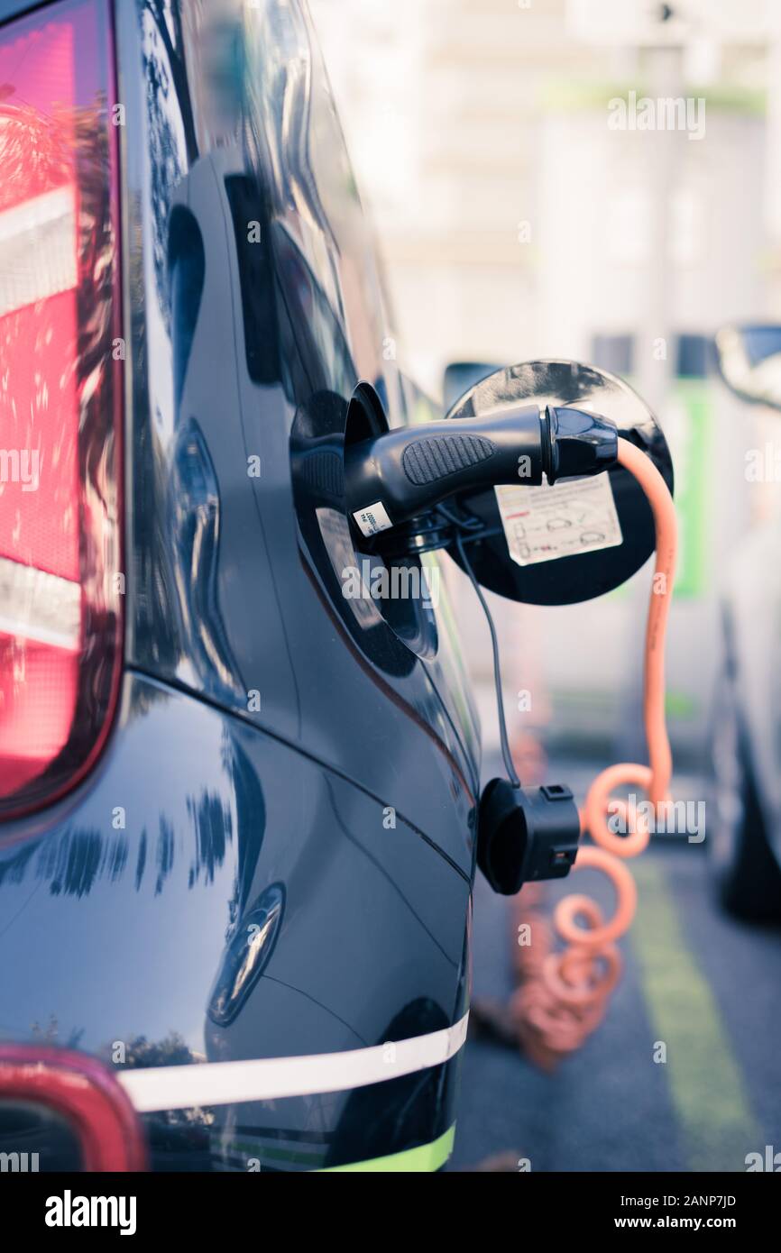 Electric car recharging with charge cable and plug leading to charge ...