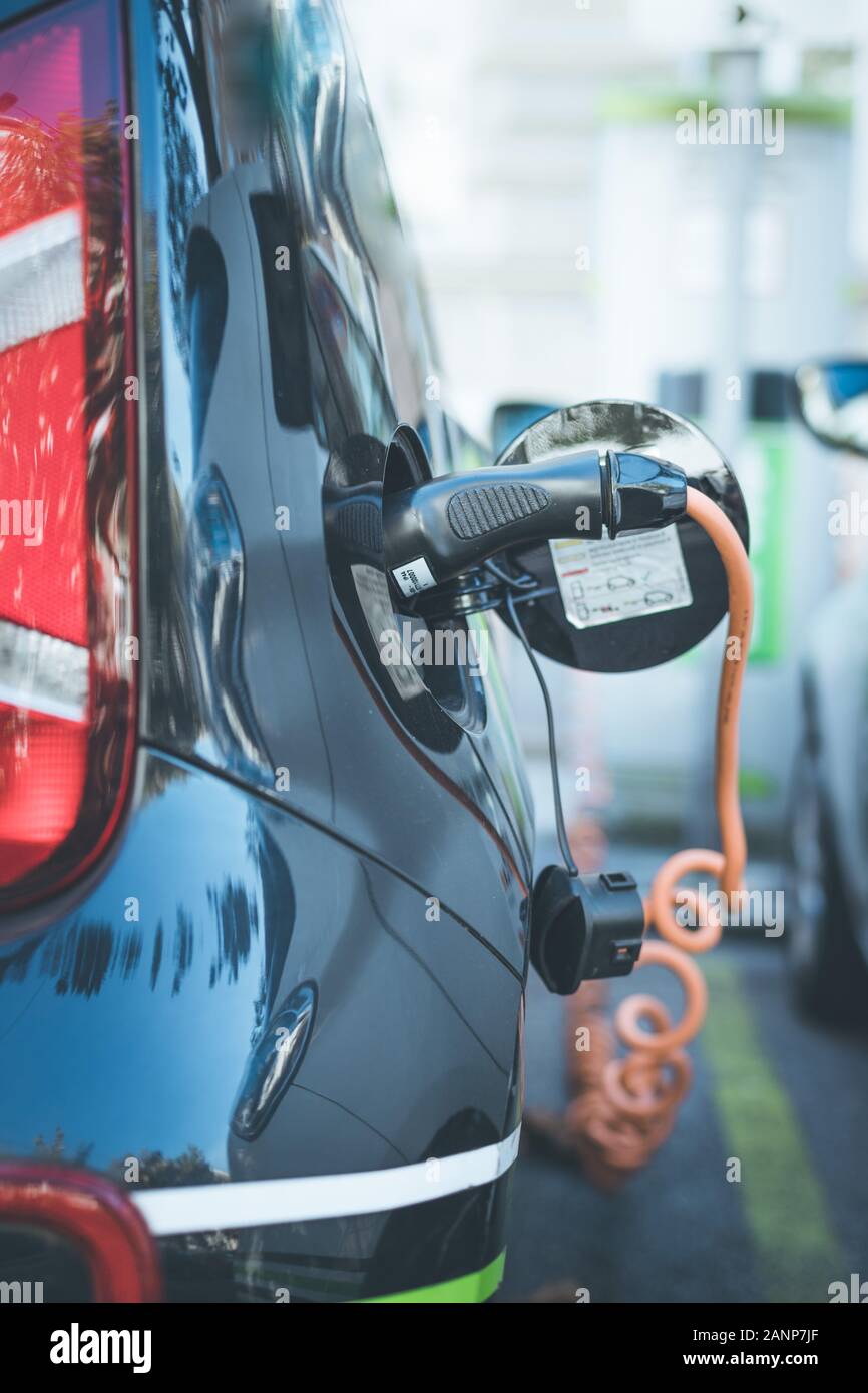 Electric car recharging with charge cable and plug leading to charge ...