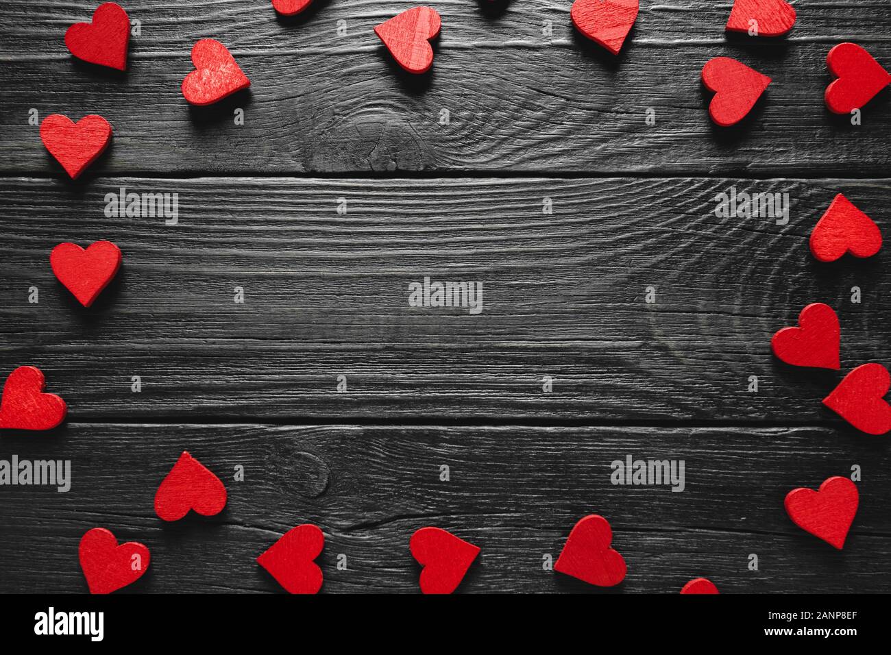 Wooden hearts forming a border on a rustic wood background. Valentines ...