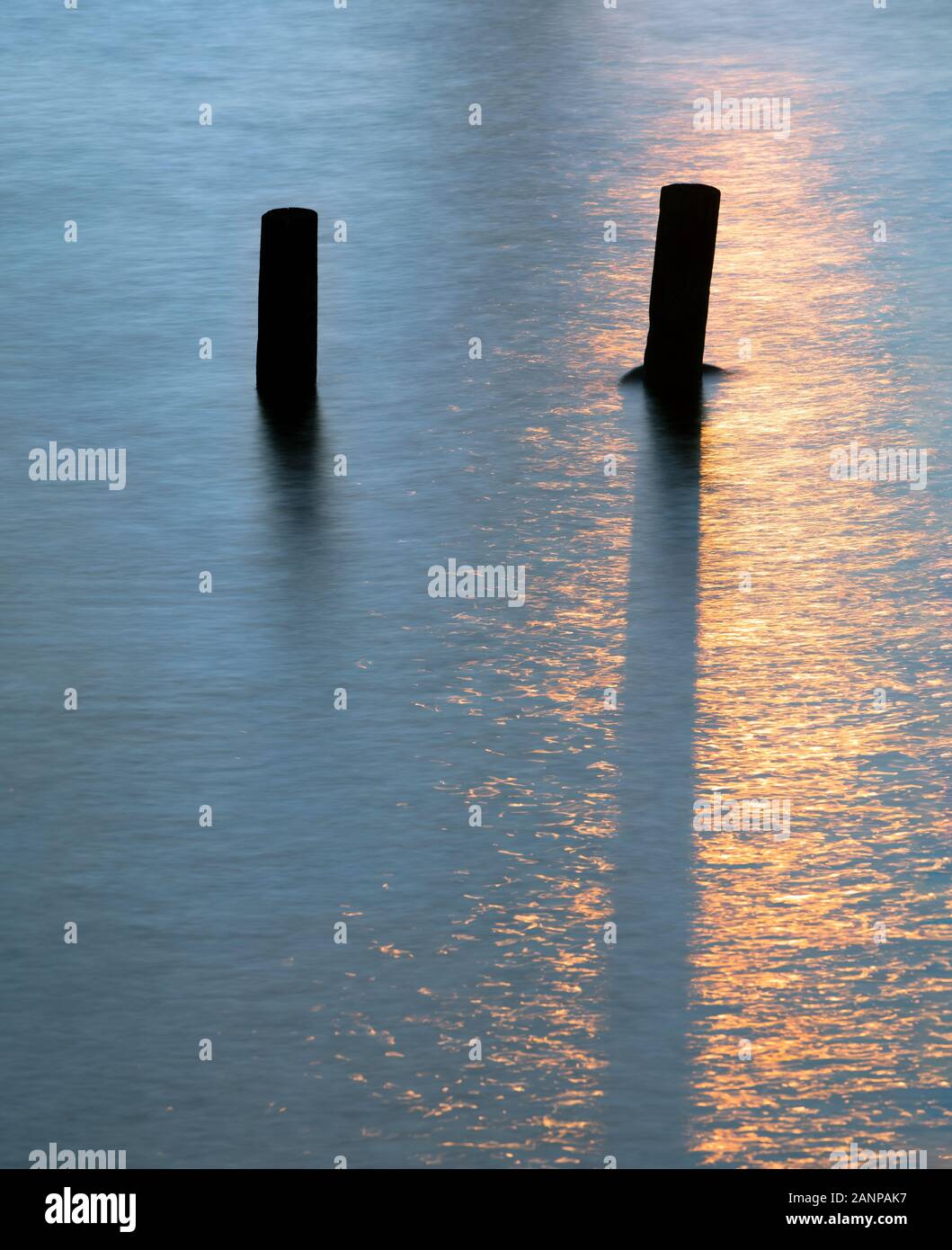 Minimalist photo of pier and pylons and water near sunset, made using ...