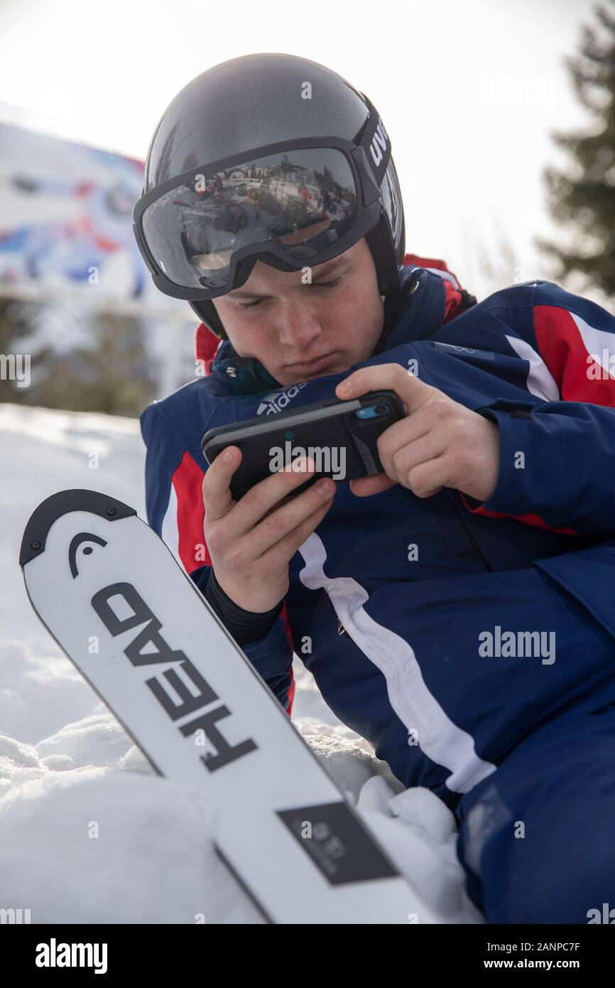 Team GB alpine skier Jack Cunningham watching the OIS broadcast of the ...