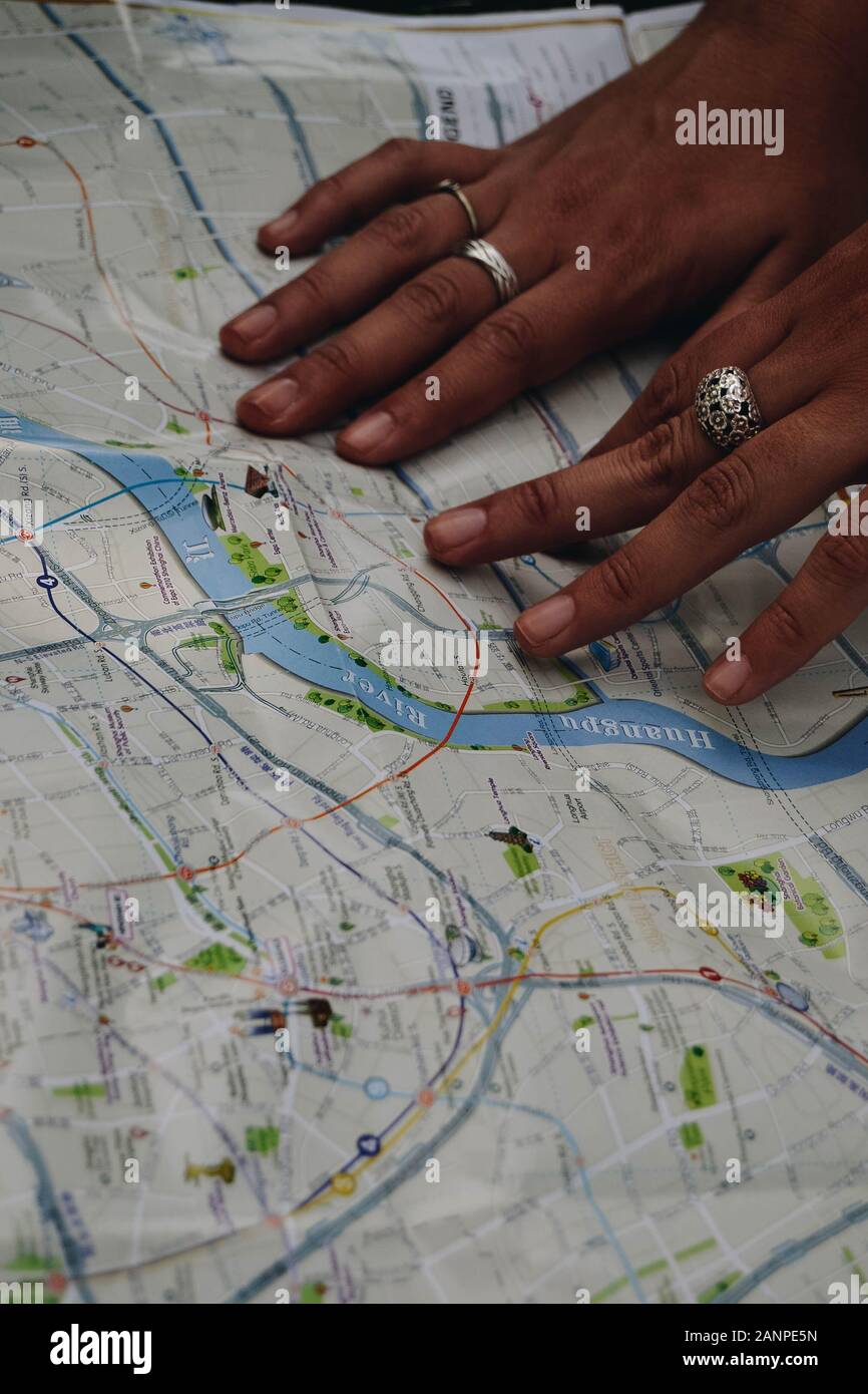 Hands in a map Stock Photo - Alamy