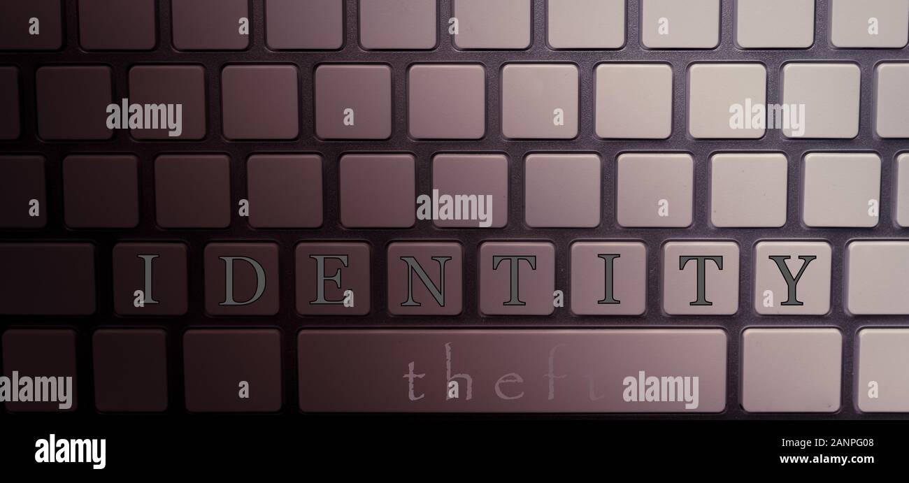 Silver keyboard with words Identity theft Stock Photo - Alamy