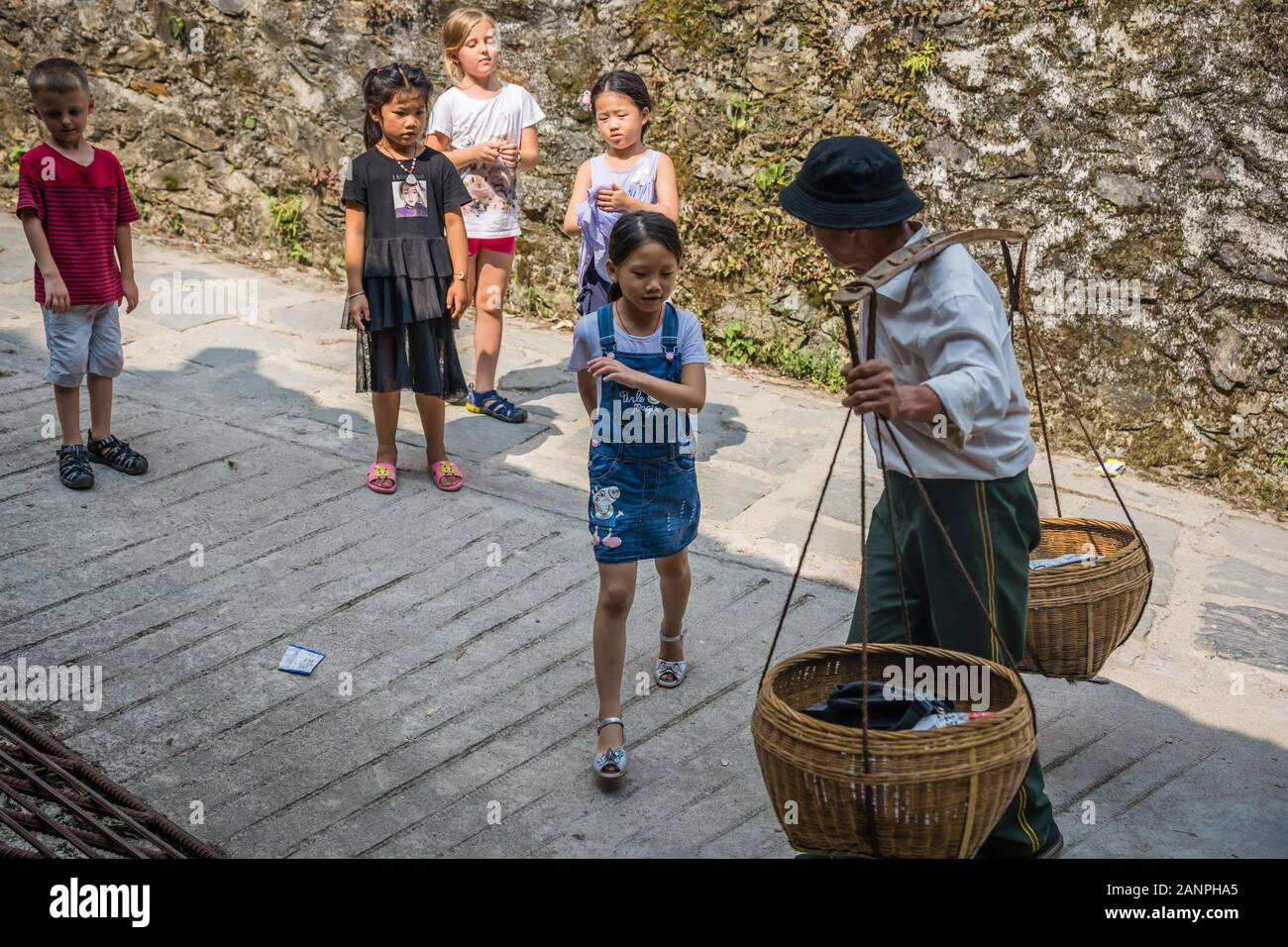 Pingan, China - August 2019 : Curious village children surrounding Old ...