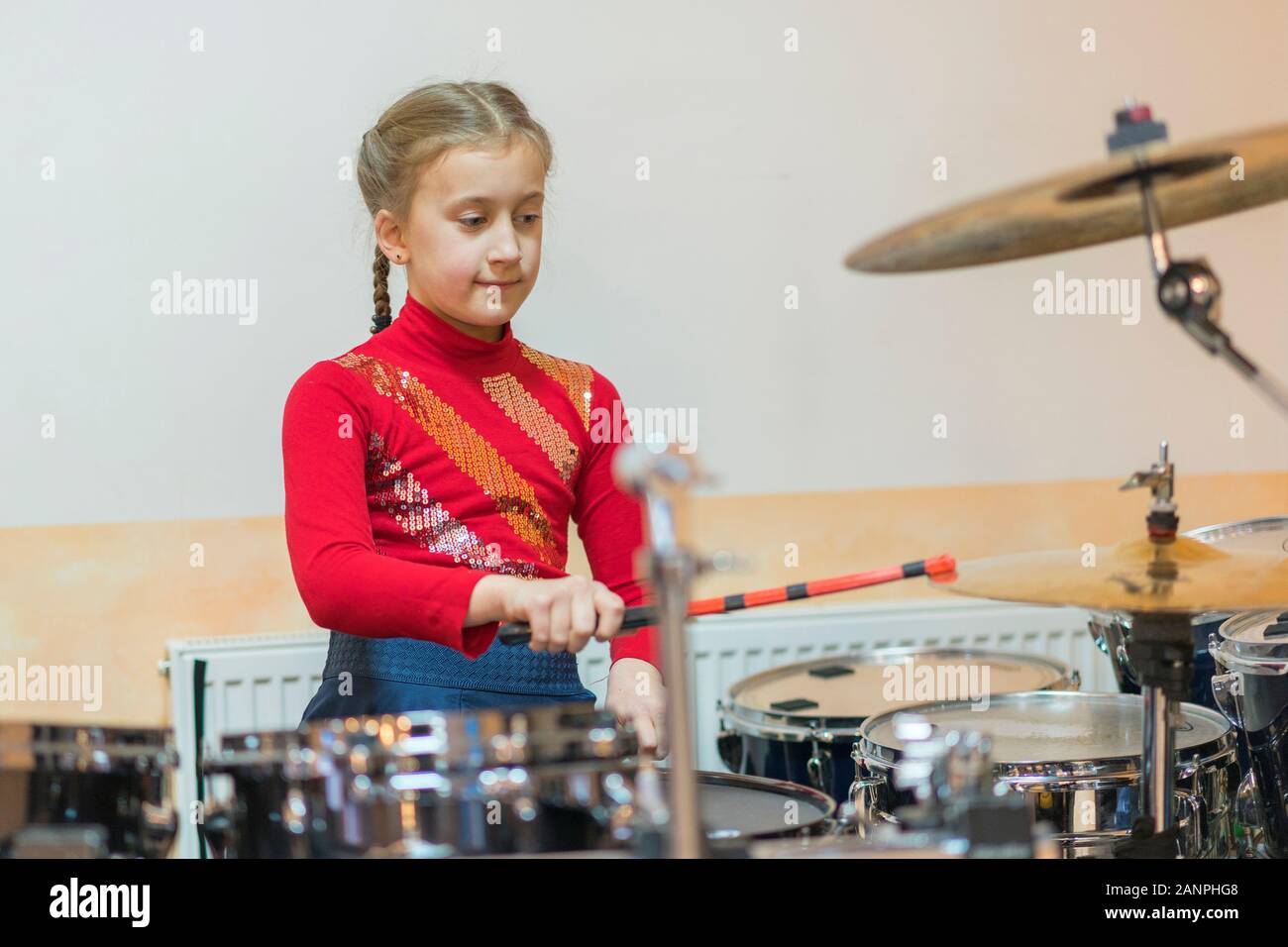 Teen girl playing the drums. Teen girls are having fun playing drum ...