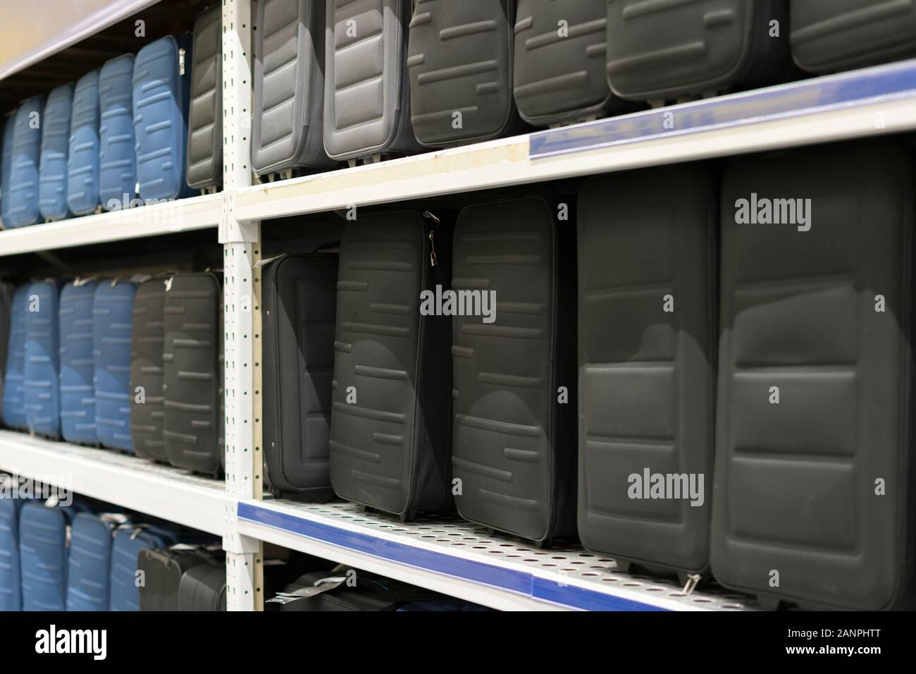 Black suitcases on a shelf in a store. Travel concept Stock Photo - Alamy