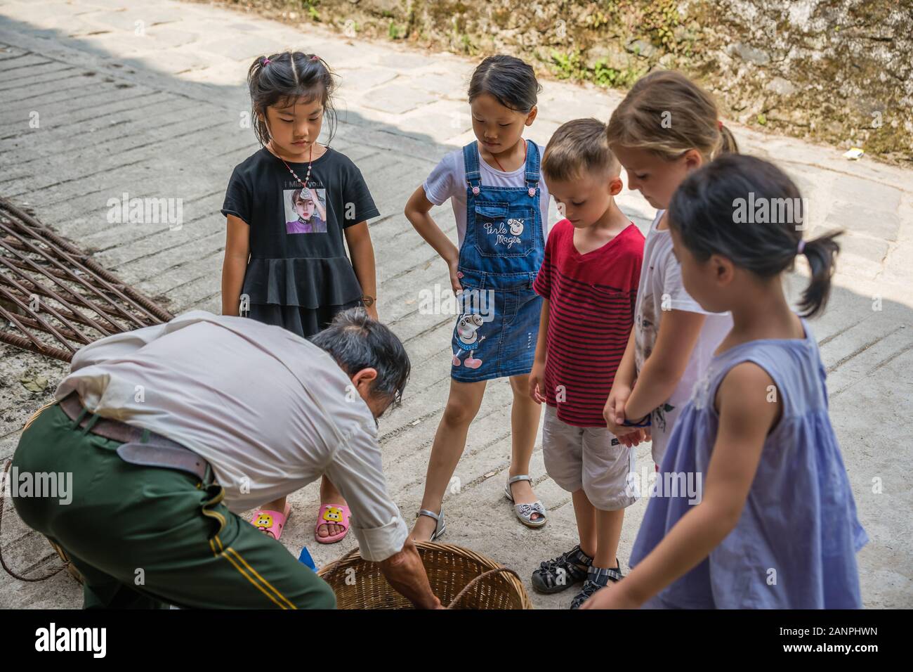 Pingan, China - August 2019 : Curious village children looking inside ...