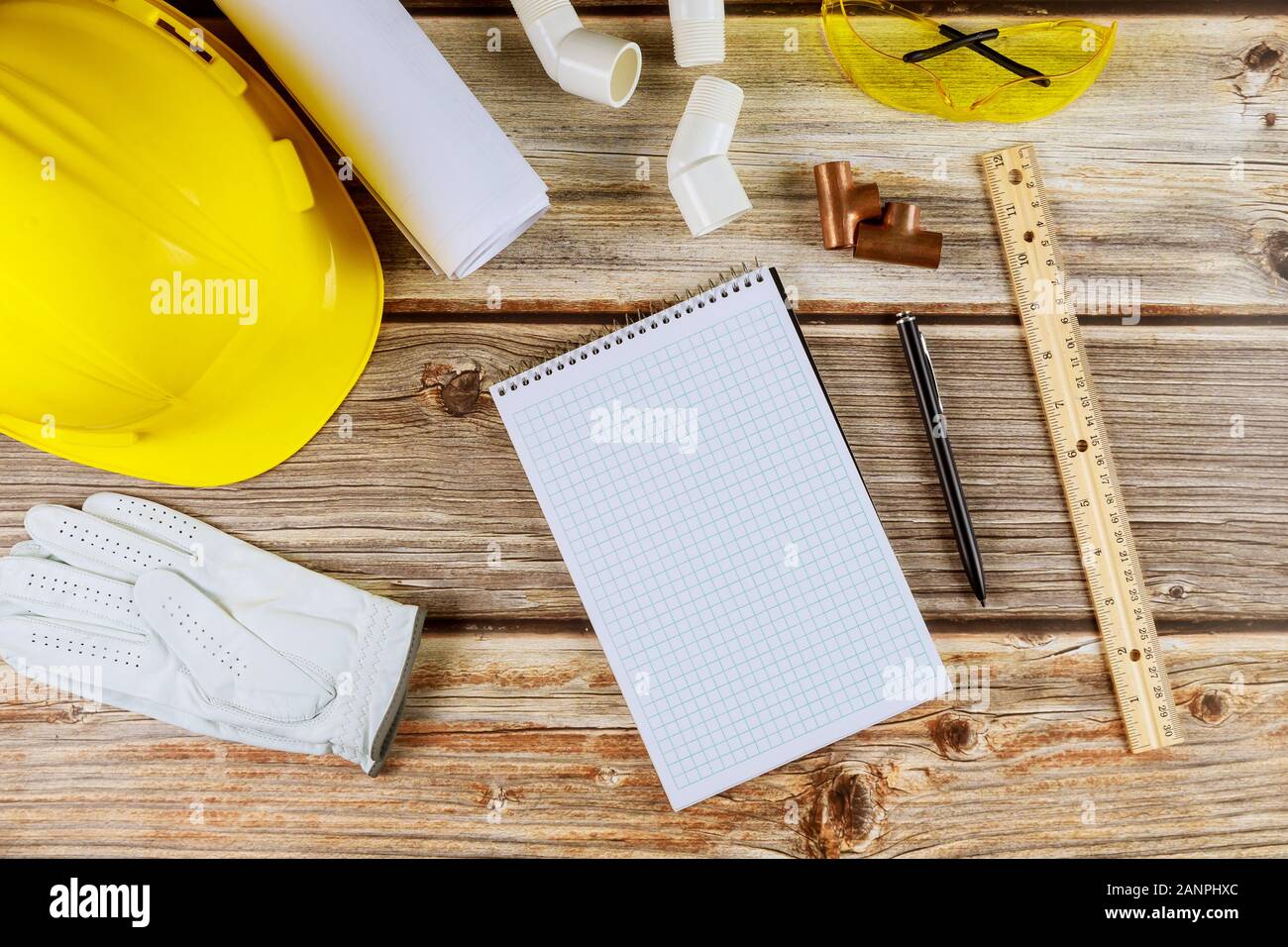Building construction on blueprints with tools and helmet on notebook ...