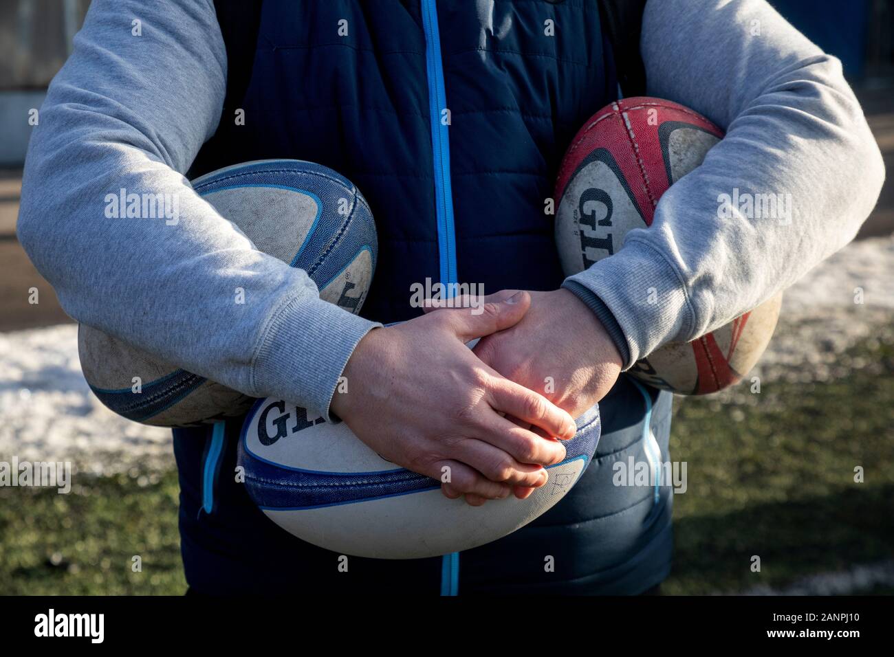 a coach holds the Rugby balls on a stadium during a team training Stock ...