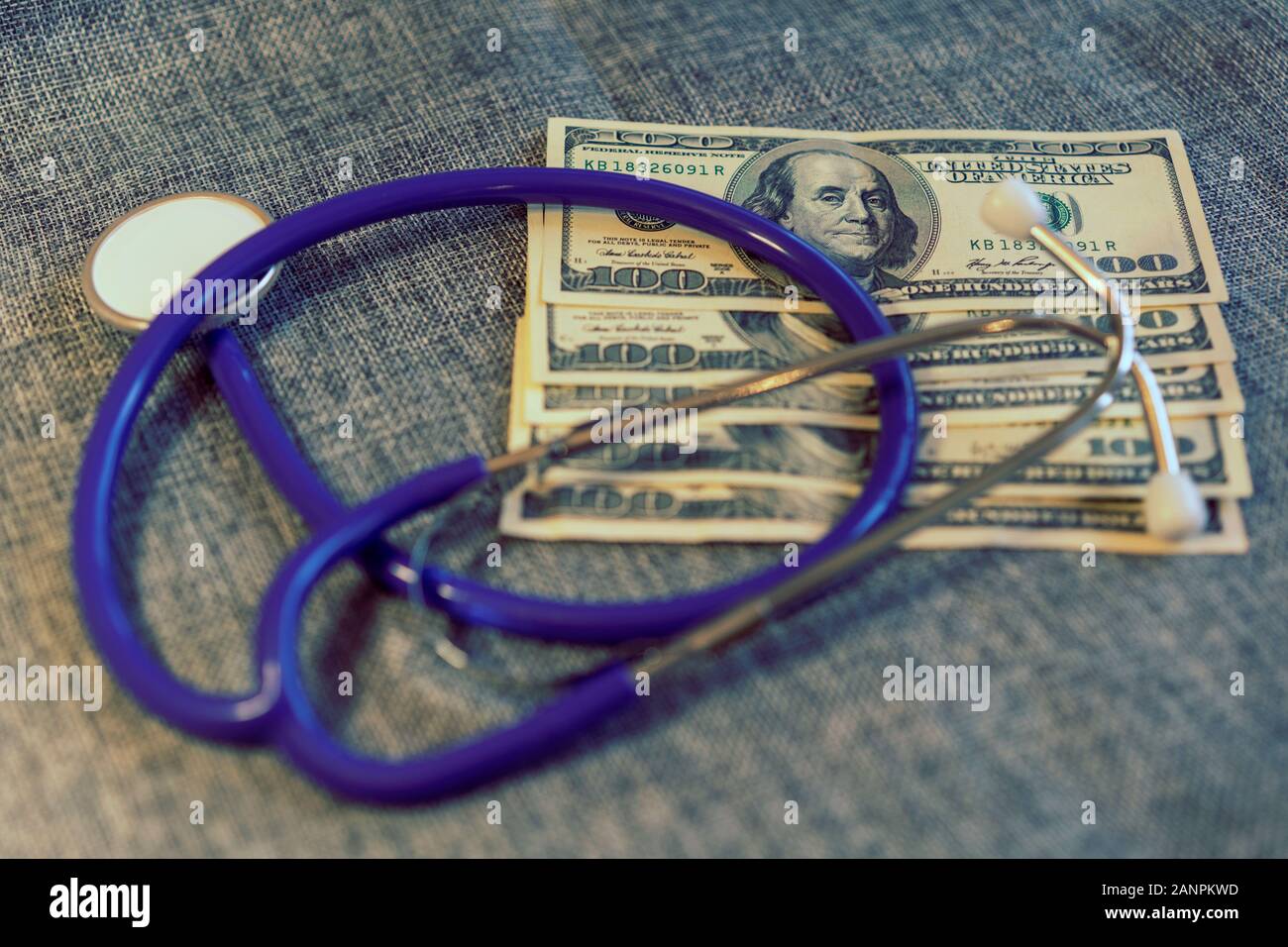 Examination of financial condition: Stethoscope on pile of U.S. dollar ...