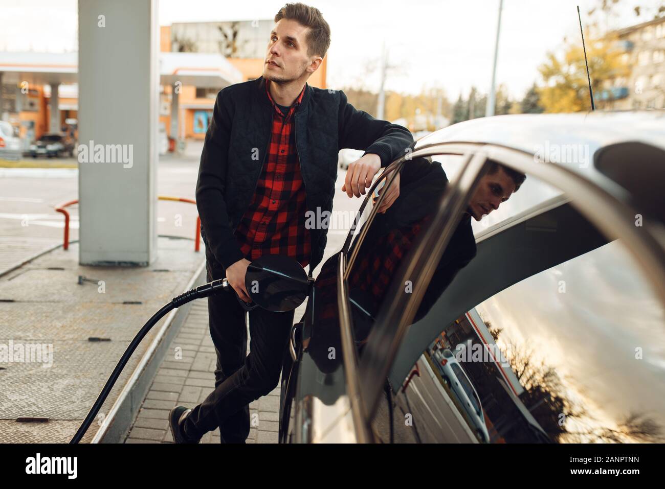 Man fuels vehicle on gas station, bottom view Stock Photo - Alamy