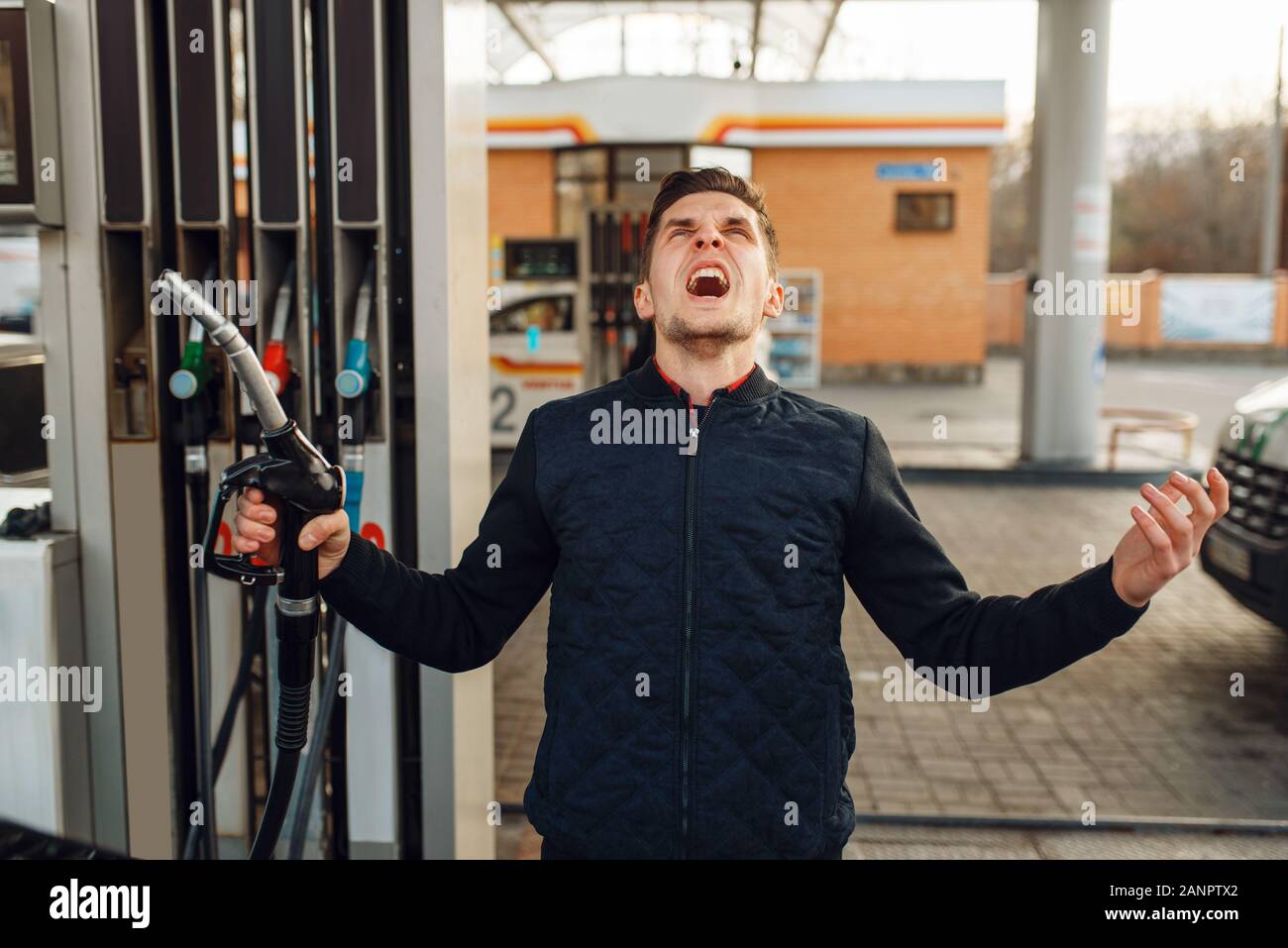 Depressed man cries on gas station, fuel filling Stock Photo - Alamy