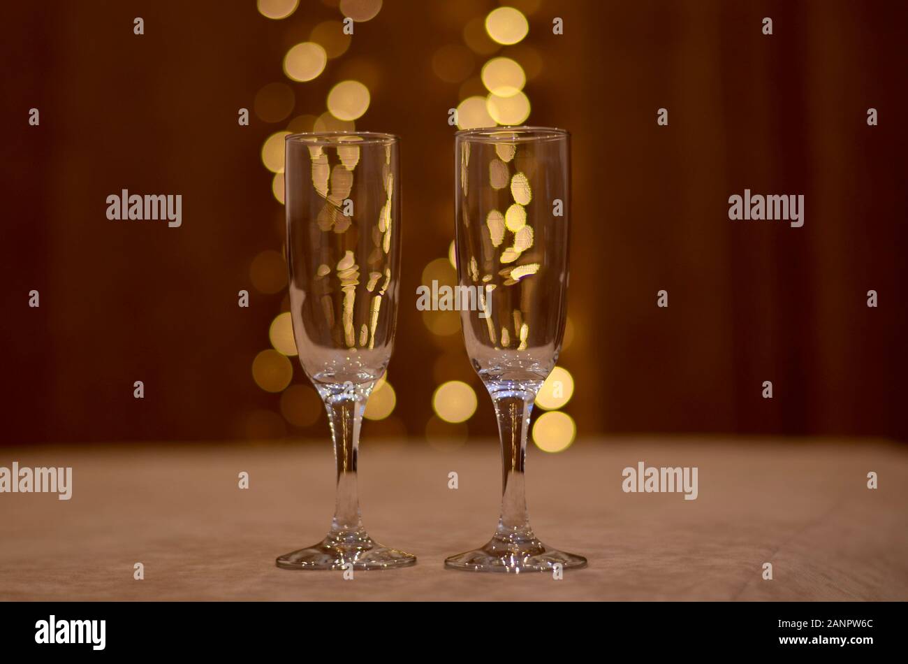 Two glasses of transparent bubbles filled with lights sideways on the ...