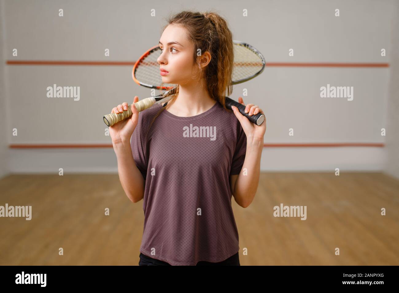 Female player with squash racket in action Stock Photo - Alamy