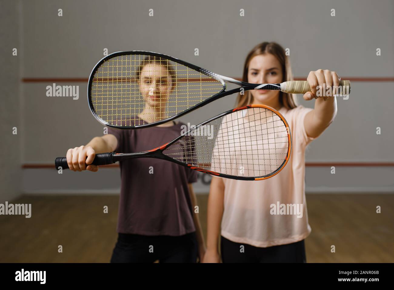Two female players shows squash rackets Stock Photo - Alamy