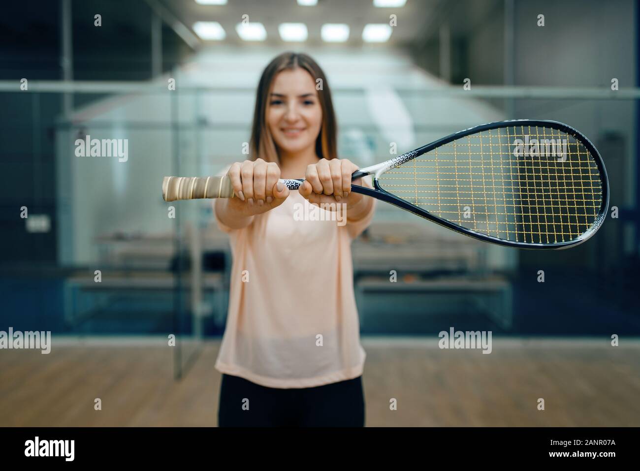 Female player shows squash racket on court Stock Photo - Alamy