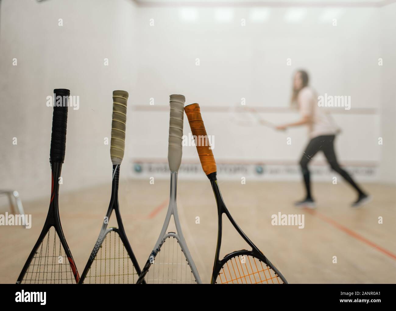 Squash rackets, female player on background Stock Photo - Alamy