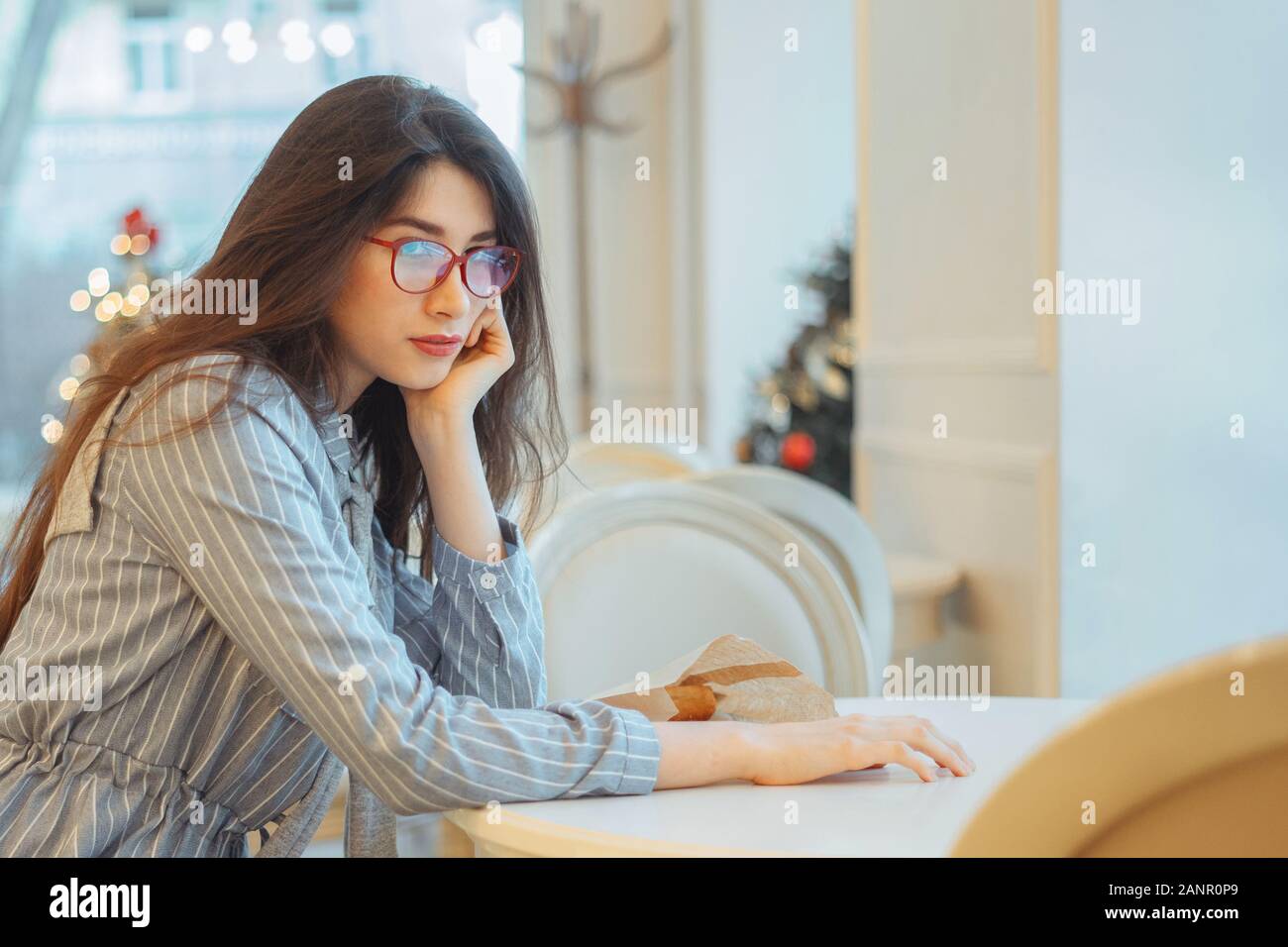 Beautiful girl in a cafe drinking hot tea Stock Photo - Alamy