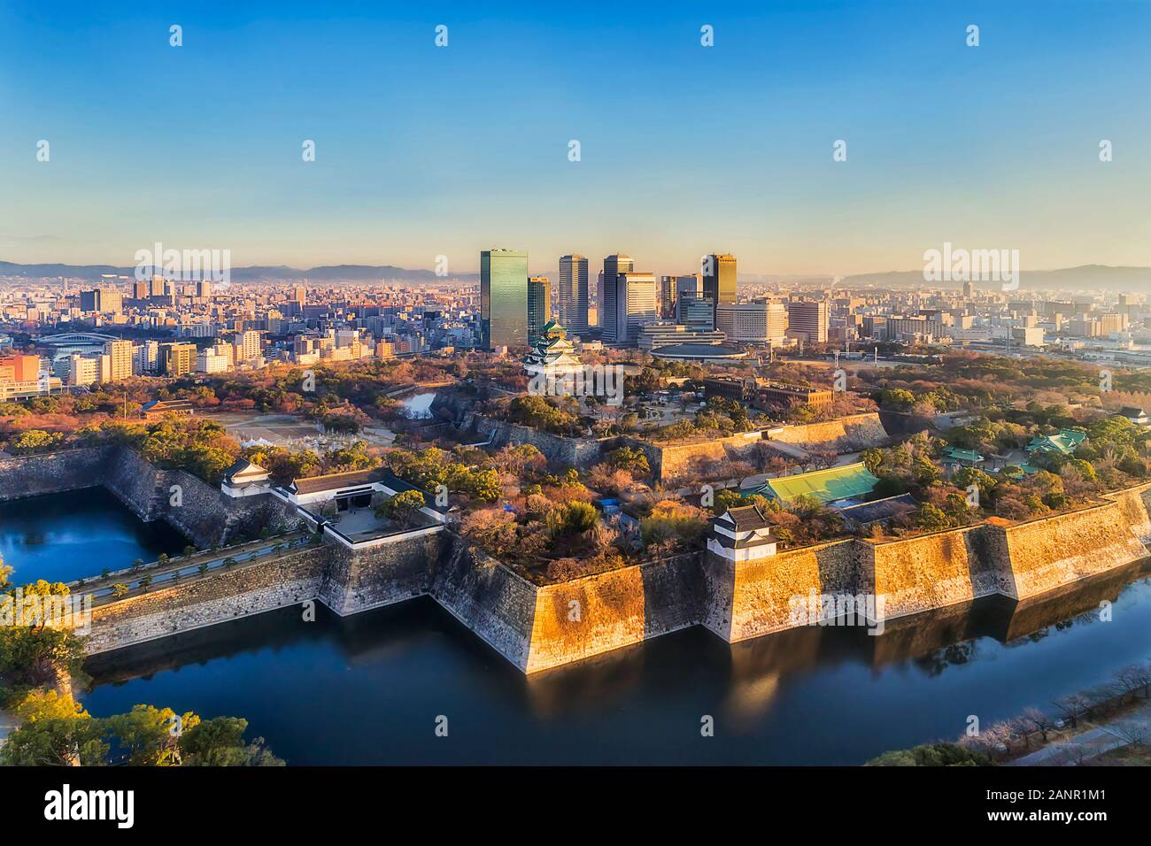 Osaka city around famous shogun castle with water moat in soft morning ...